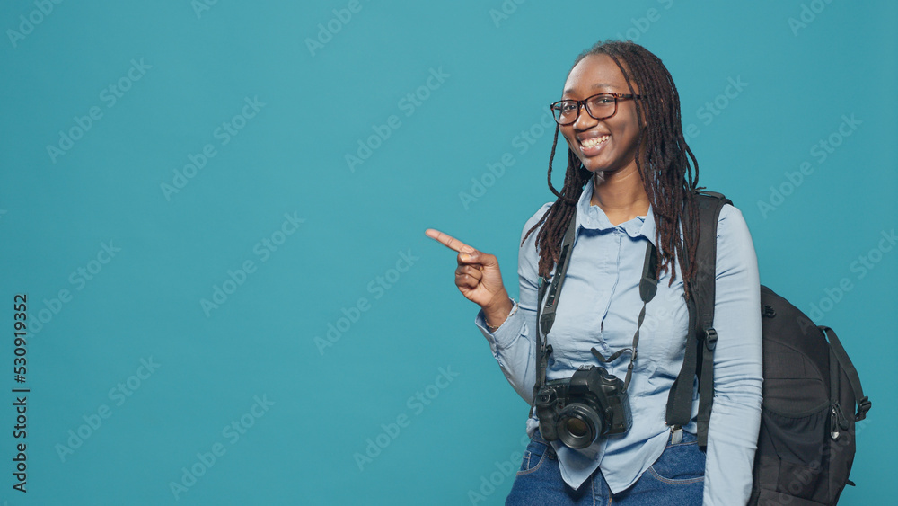 Photographer pointing at left and right side in studio, indicating ...