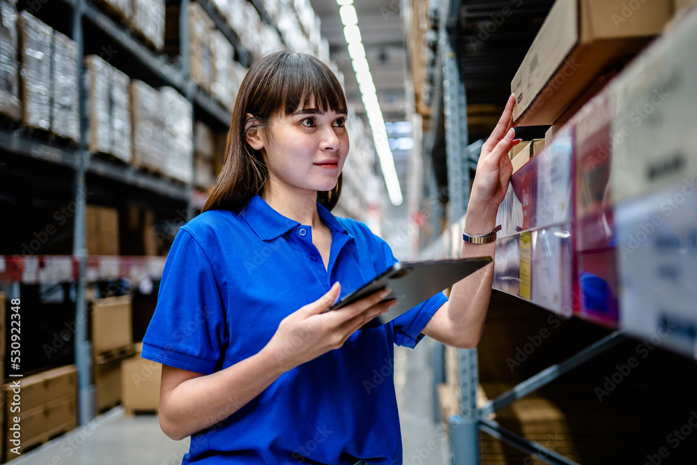 Women warehouse worker using digital tablets to check the stock ...