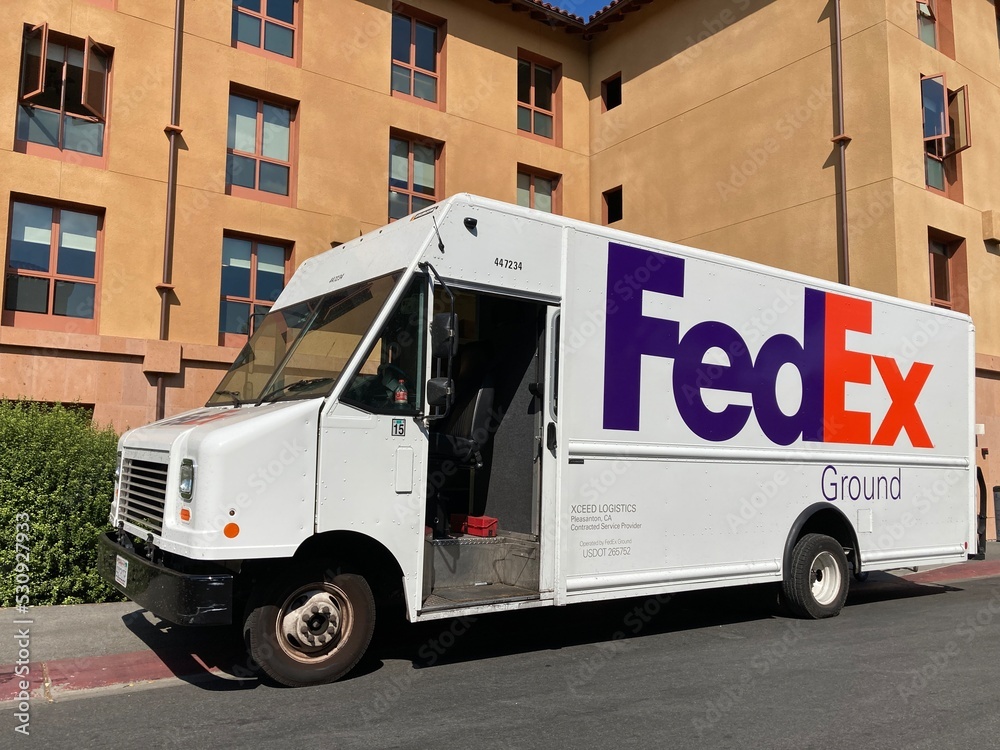 FedEx Ground delivery truck parked at residential building. Side view ...
