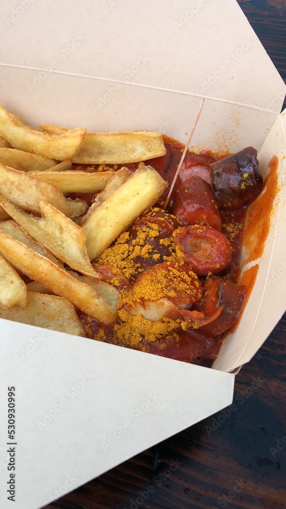 Currywurst with fries in a box in Berlin. Typical food of Germany ...