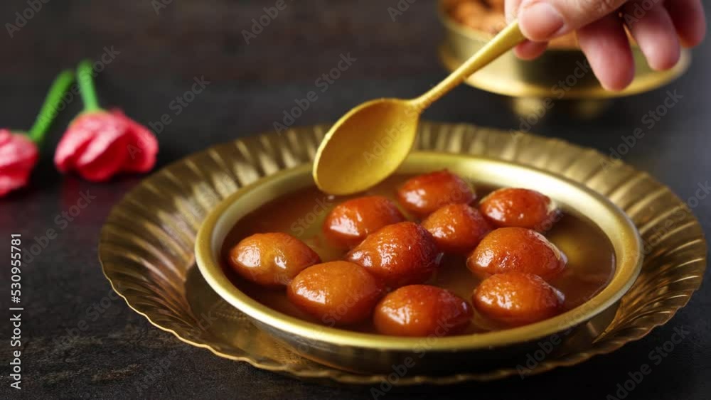 Video Stock Woman hand pouring sugar syrup Gulab jamun , gulaab jamun ...