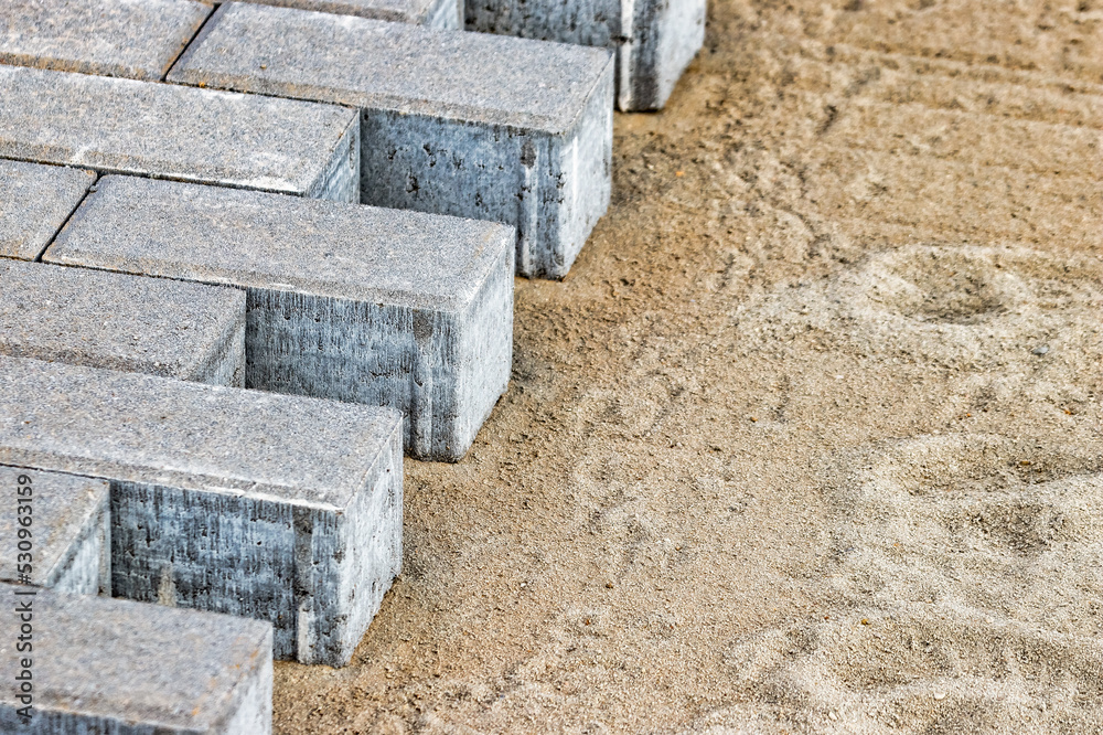 Pavement repairs and paving slabs laying on the prepared surface, with ...