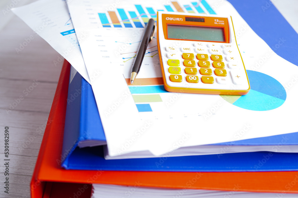 Calculator on chart and graph spreadsheet paper. Finance development ...