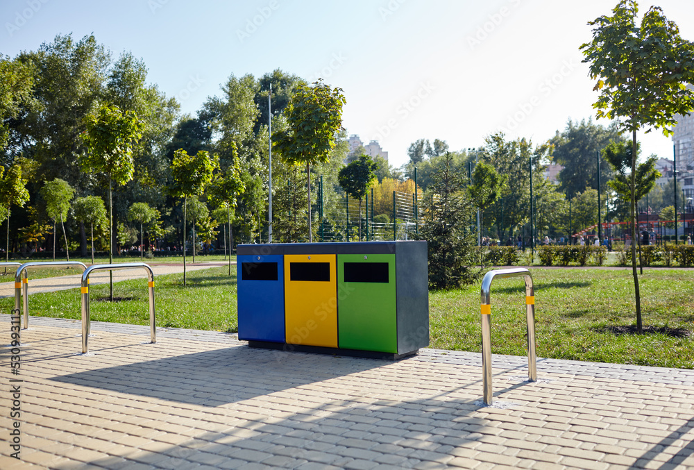 Garbage cans in the city park. Garbage container in a public park ...