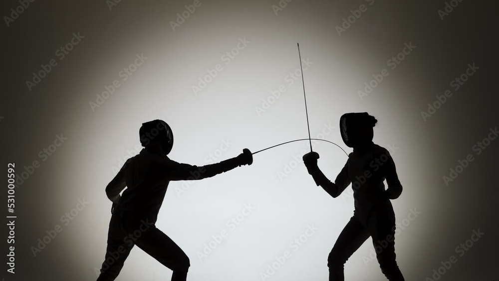 Side view of black silhouettes two young female swordswoman with ...