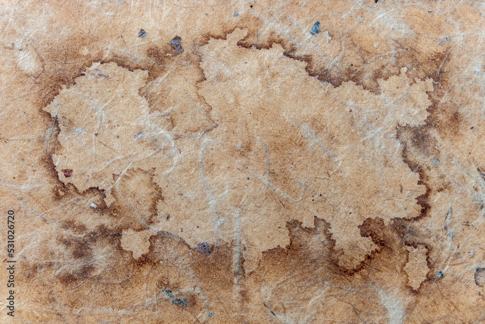Old, brown-stained blank parchment paper background which has an aged ...