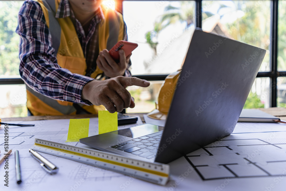 engineer working in office draw a construction project An architect's ...