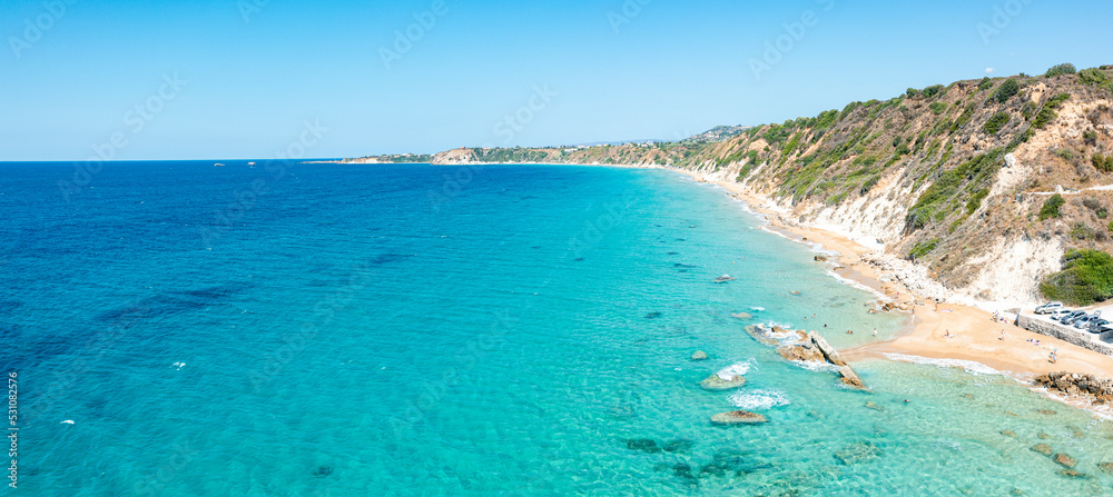 Aerial view of the crystal clear sea washing the golden sand of ...