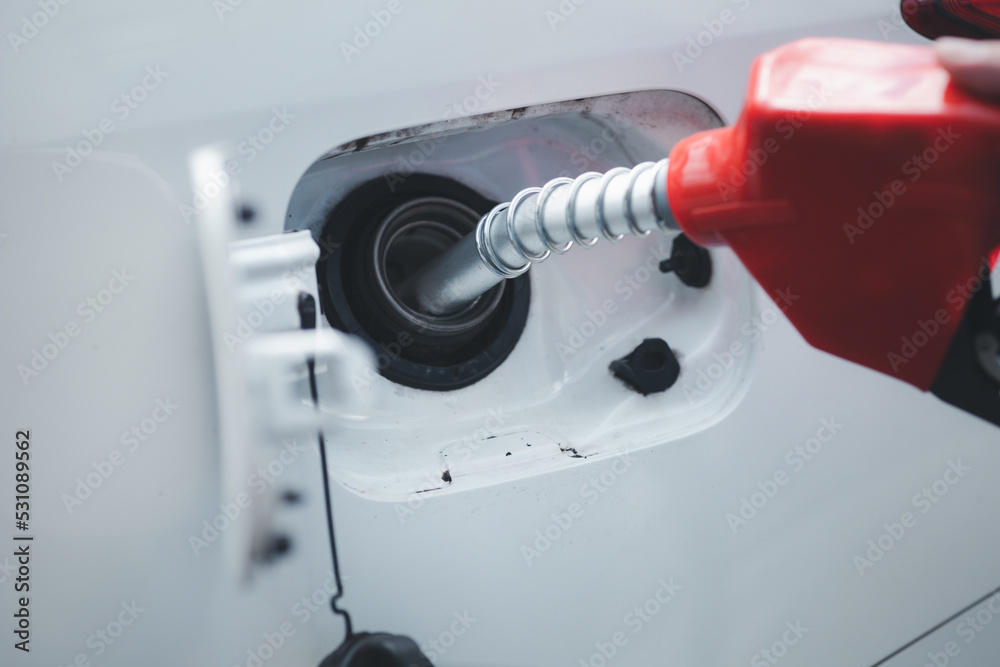 Gas station workers are refueling cars, fuel consumption, gasoline ...