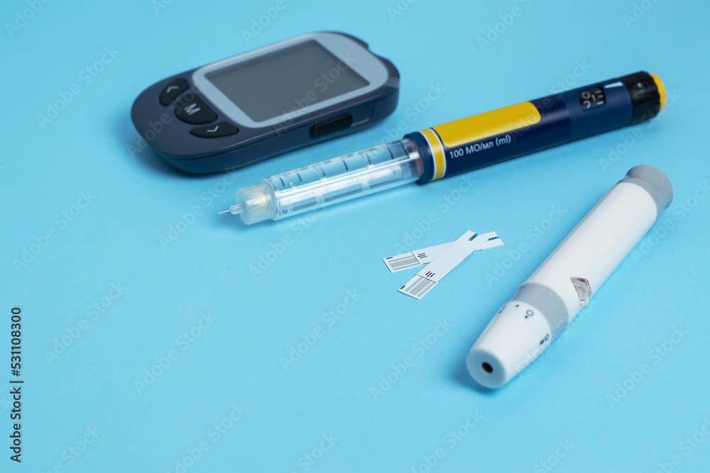 Measuring blood sugar. Glucometer, insulin pen, lancet and test strip ...
