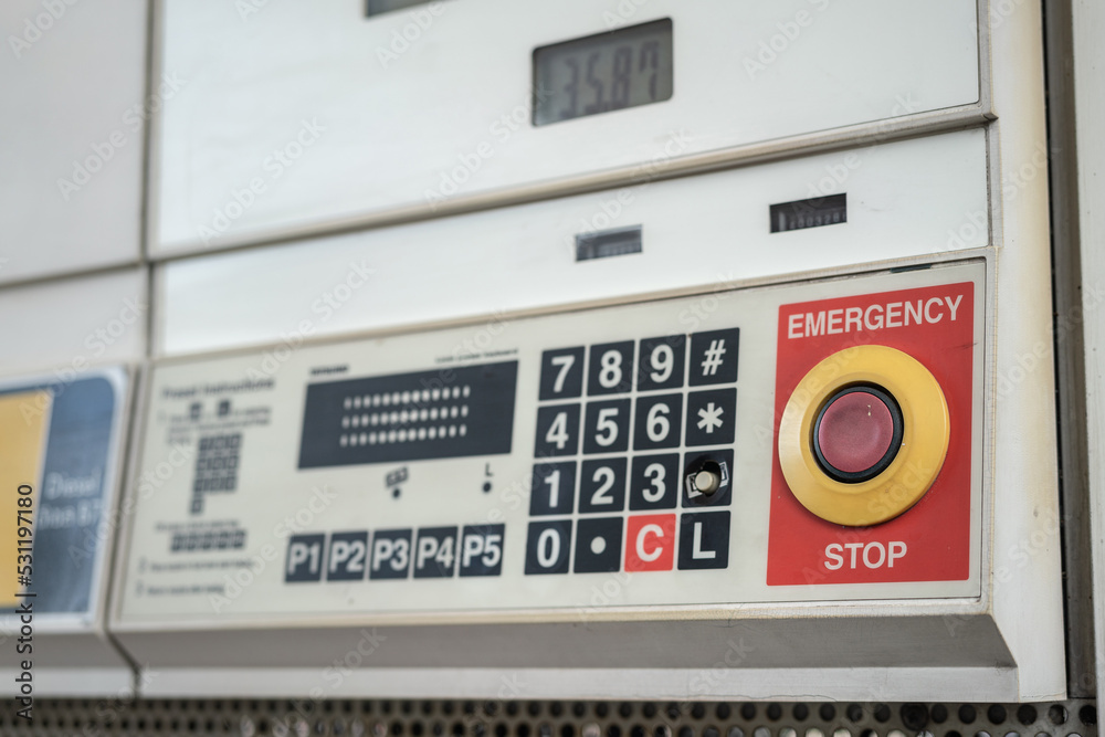 An emergency stop button on the gasoline refuel control panel machine ...