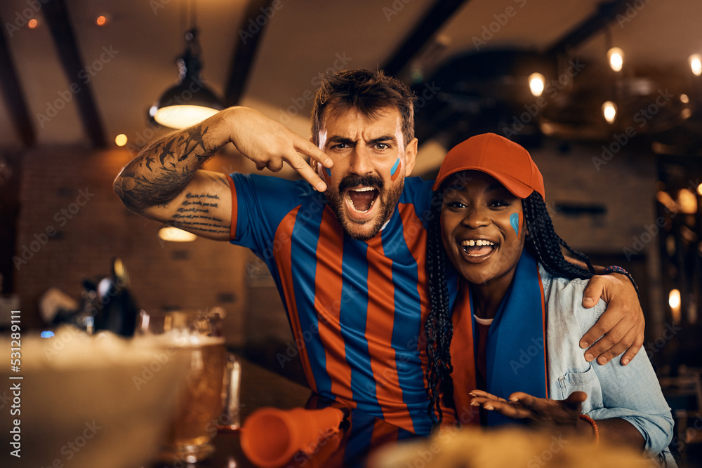 Passionate couple of sports fans cheering for their team in pub. Stock ...