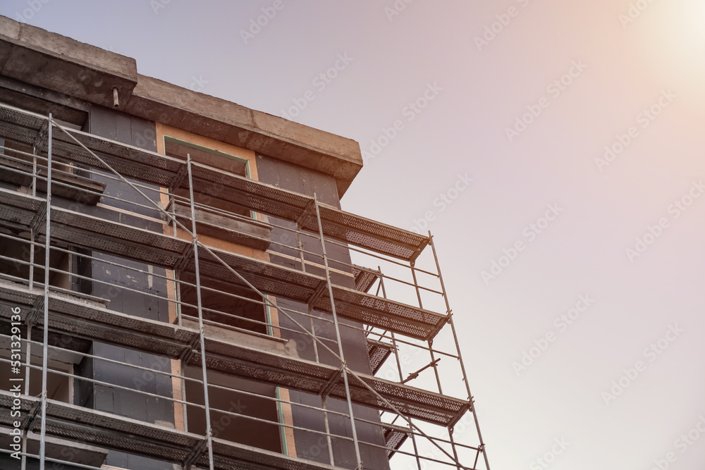 Construction of a building using scaffolding, civil works and building ...