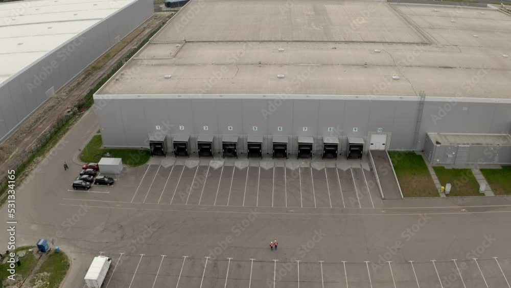 Engineers walk to check large storage terminal with loading docks for ...
