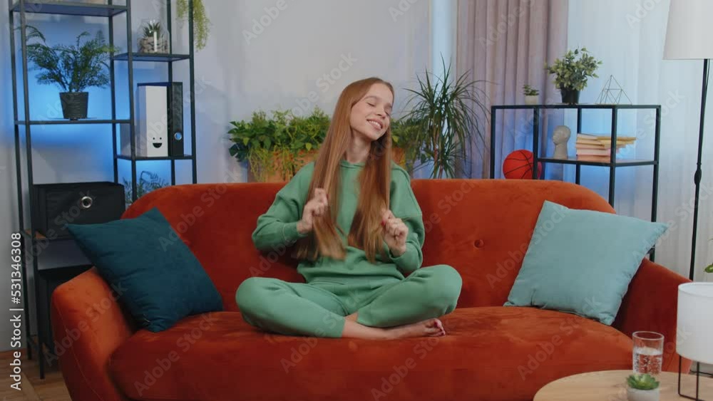 Trendy cheerful positive teen girl having fun dancing, moving to rhythm ...