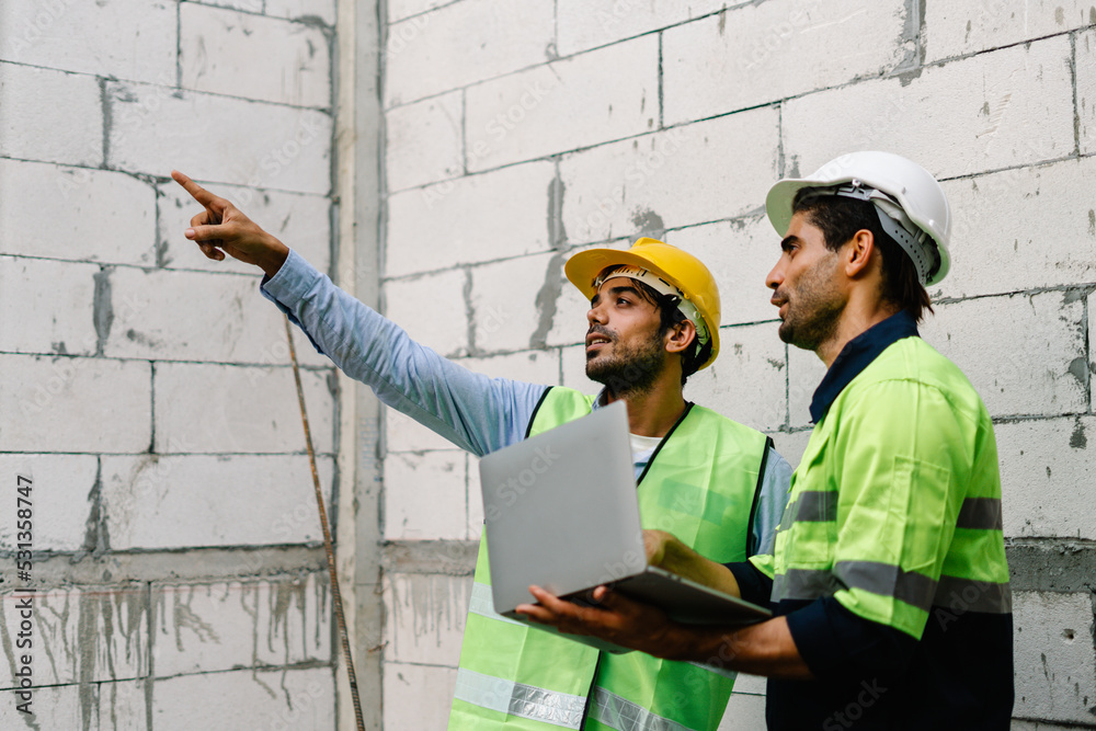 Construction worker and contractor on active construction site holding ...