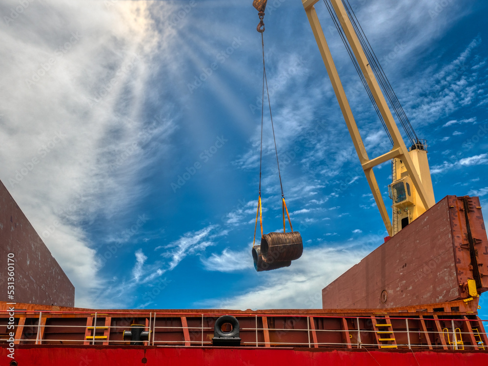 Port operation is discharging steel wire rod from cargo hold of the ...