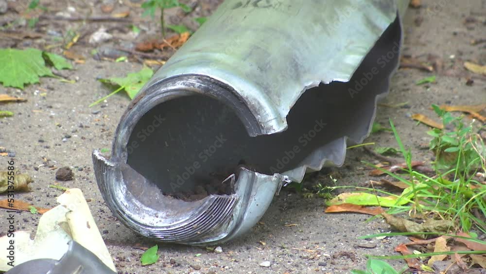 Shell casing, a metal shell from an exploded shell on the street of a ...