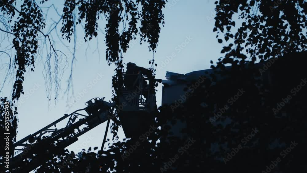 Rescue services team, firefighters in helmets extinguish fire, spraying ...