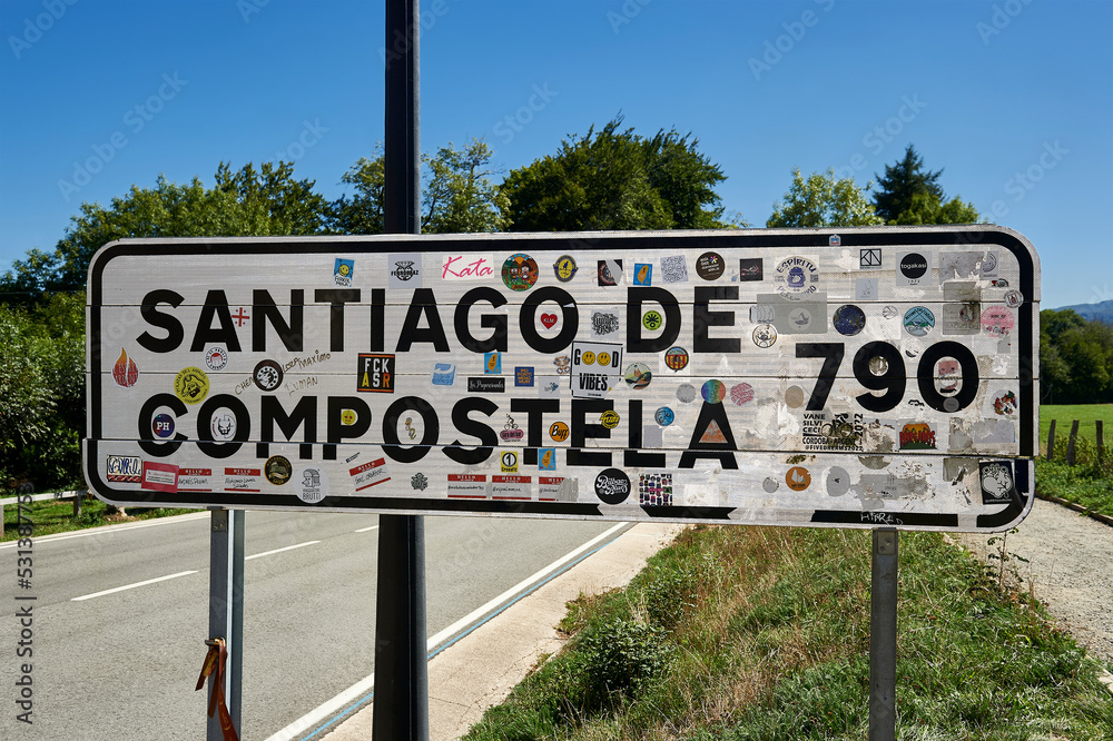 road sign indicating the distance between Roncesvalles and Santiago de ...