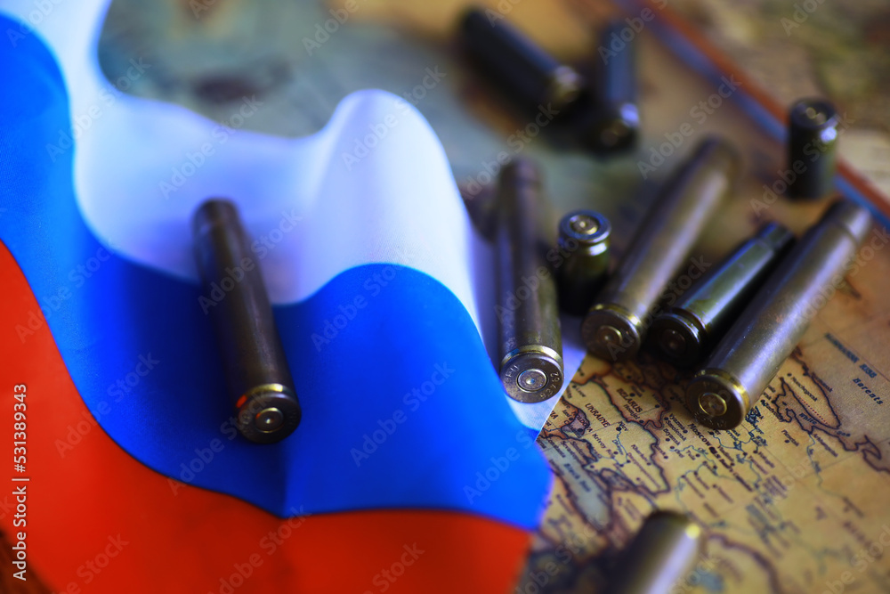 Russian flag and bullet casings on the table. Background concept ...