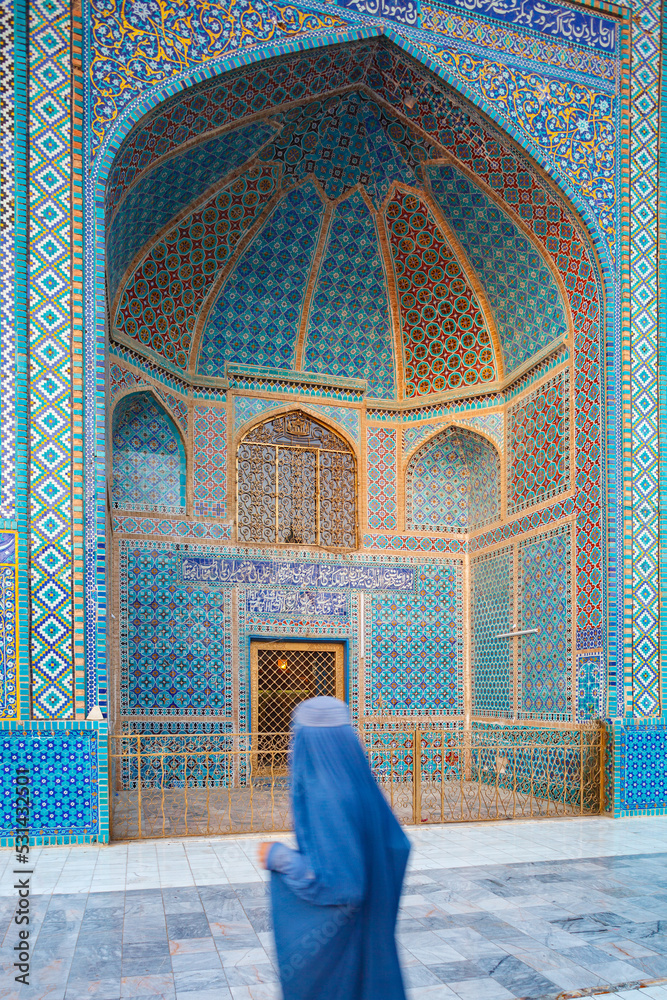 Woman with blue burka (burqa) walking in front of the Timurid Blue ...