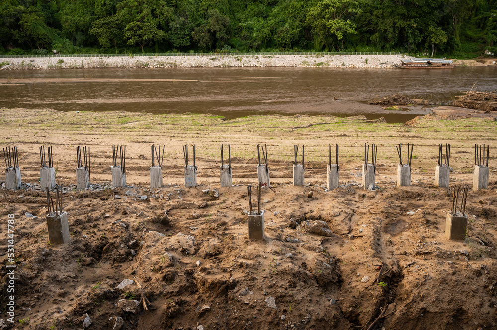 Rows of concrete piles foundation drilling in the ground in ...