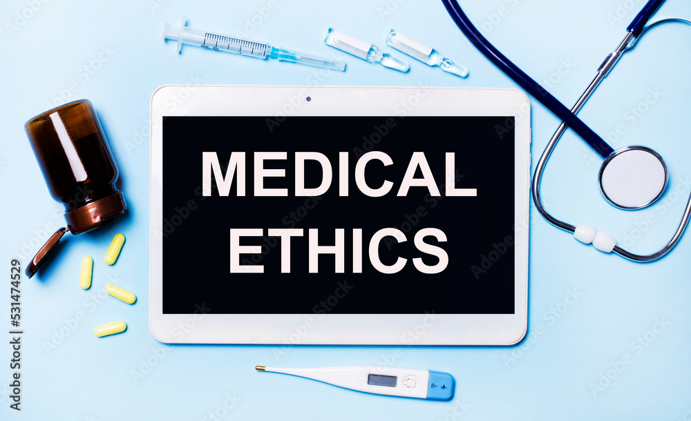 Ampoules, pills, stethoscope, thermometer, tablet with MEDICAL ETHICS ...