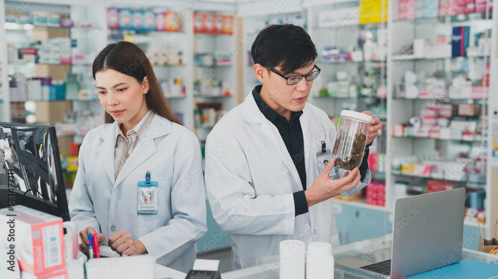 The female and male pharmacists work together as a team at the pharmacy.Pharmacy clinic business ...