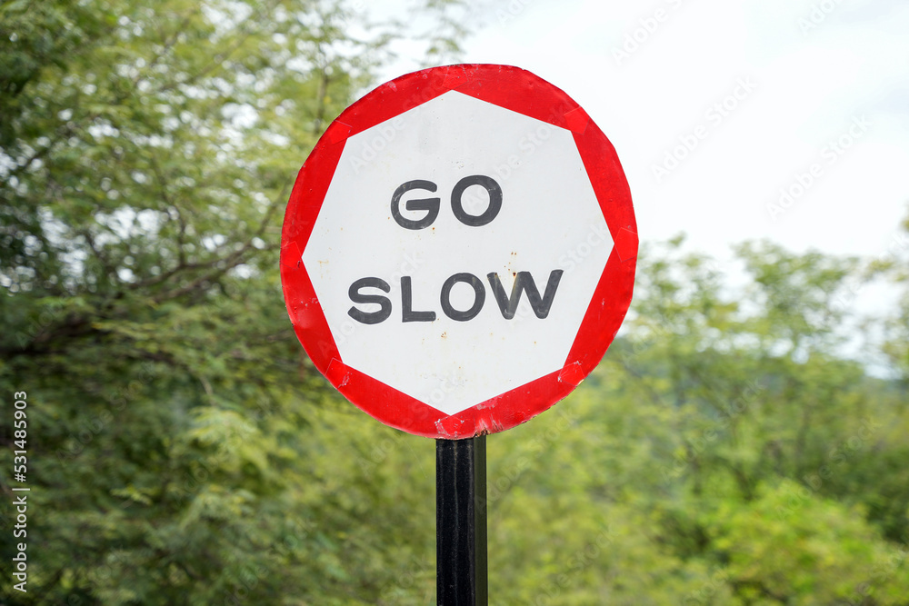 Go Slow sign Board on the road Stock Photo | Adobe Stock