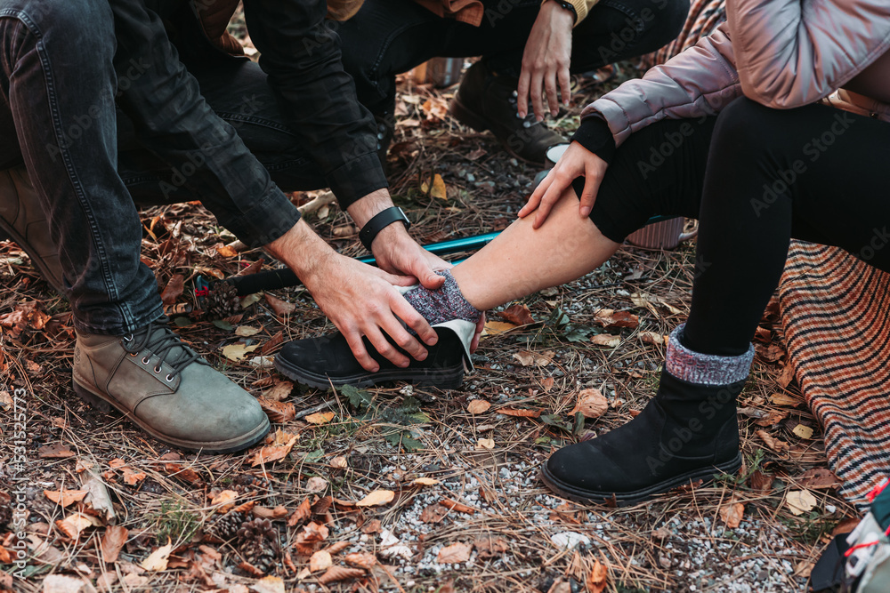 Young Woman Sprained Her Ankle While Hiking Her Friends Are Helping