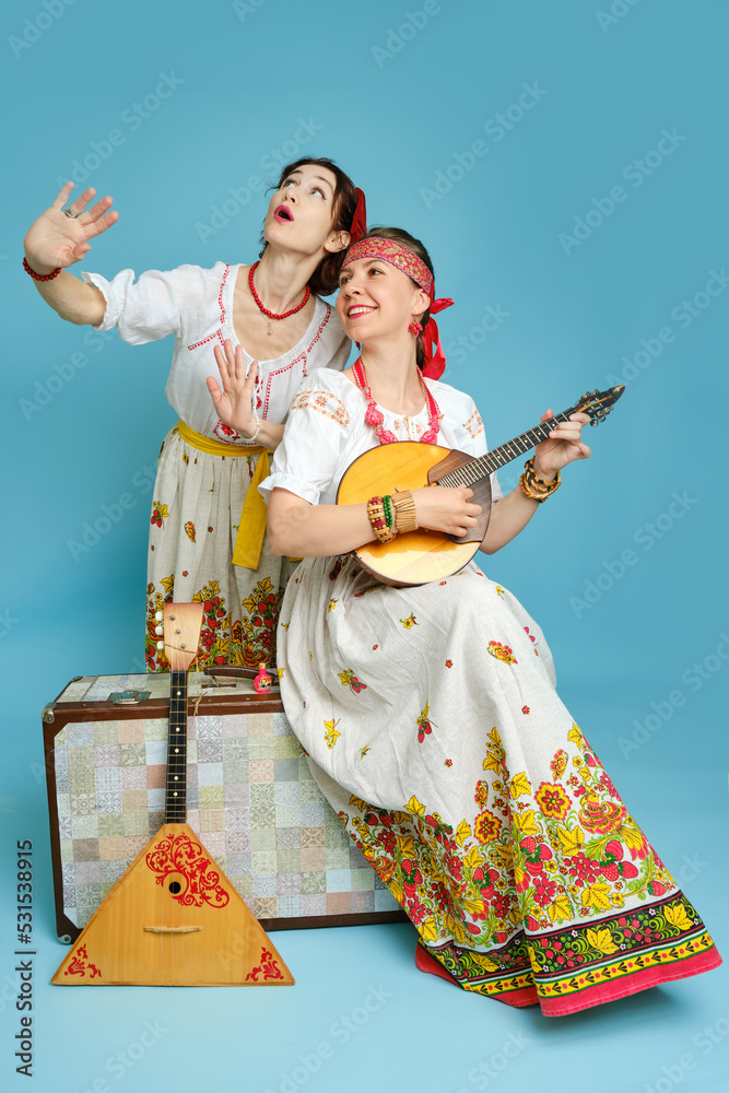 Women musicians in Russian folk dresses with musical instruments on a ...