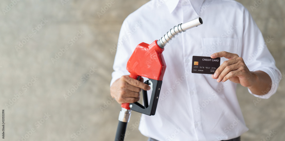 Human hand is holding red gasoline pistol pump fuel nozzle and credit ...