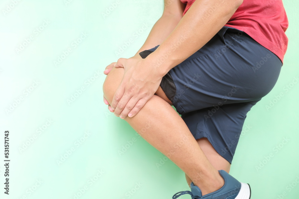 Knee pain and injury, joint arthritis concept. Young asian athlete man ...