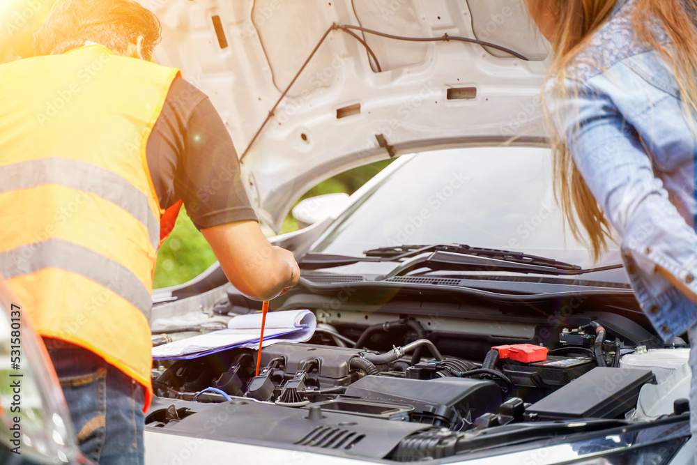 Closeup and crop motor vehicle mechanic checking engine oil to record ...
