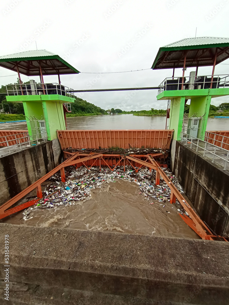 Aerial view of turbid brown forest water released by concrete dam ...