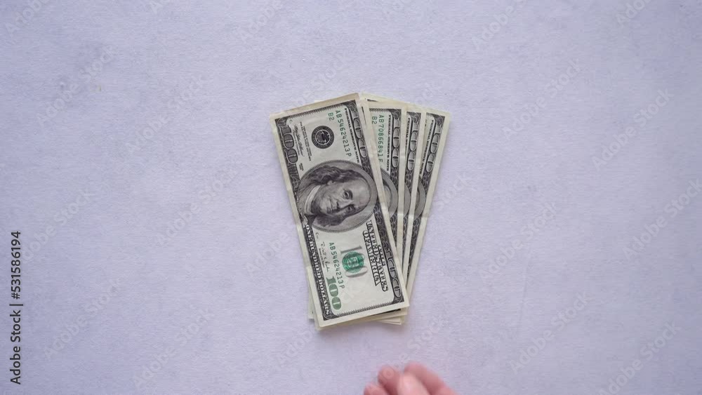 Overhead Shot Of Person's Hand Laying Down One Hundred Dollar Bills And ...