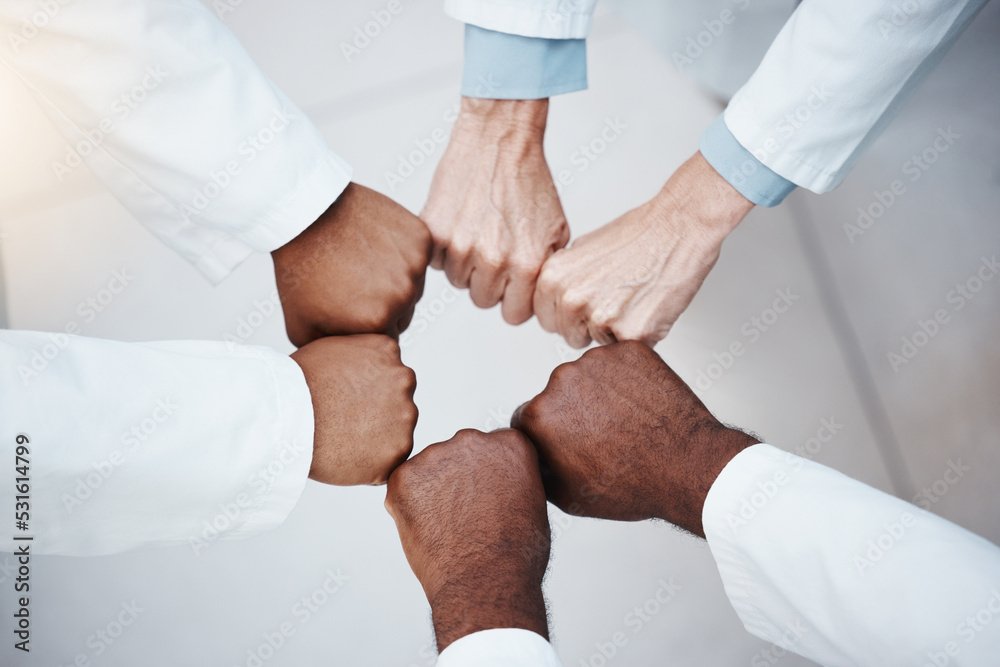 Fotografia do Stock: Doctors fist bump in teamwork motivation and ...