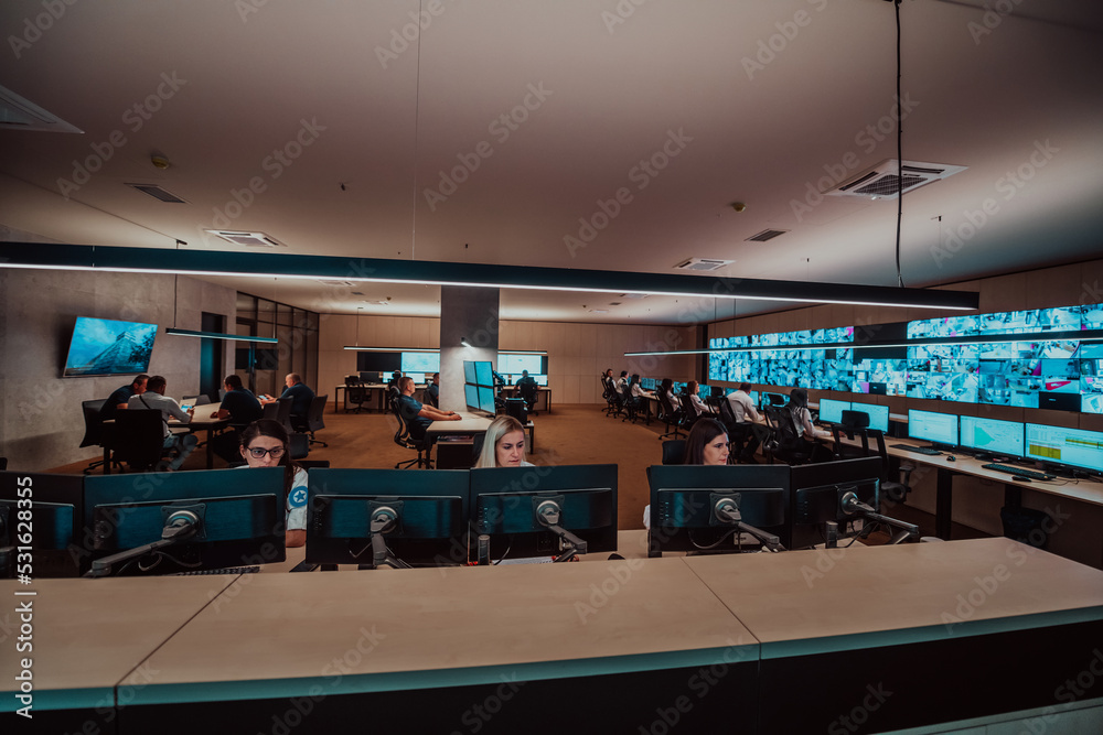 Group of Security data center operators working in a CCTV monitoring ...