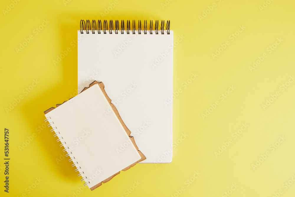 big and small notepad with spiral yellow background mocap copy space ...