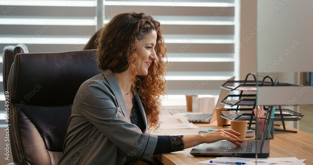 Caucasian business woman working at computer in office, receives good ...
