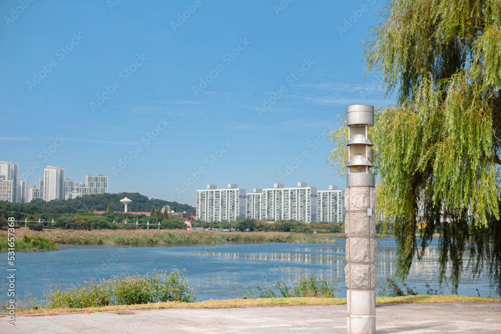 View of lake and apartment buildings at Hwarang Recreation Area park in ...