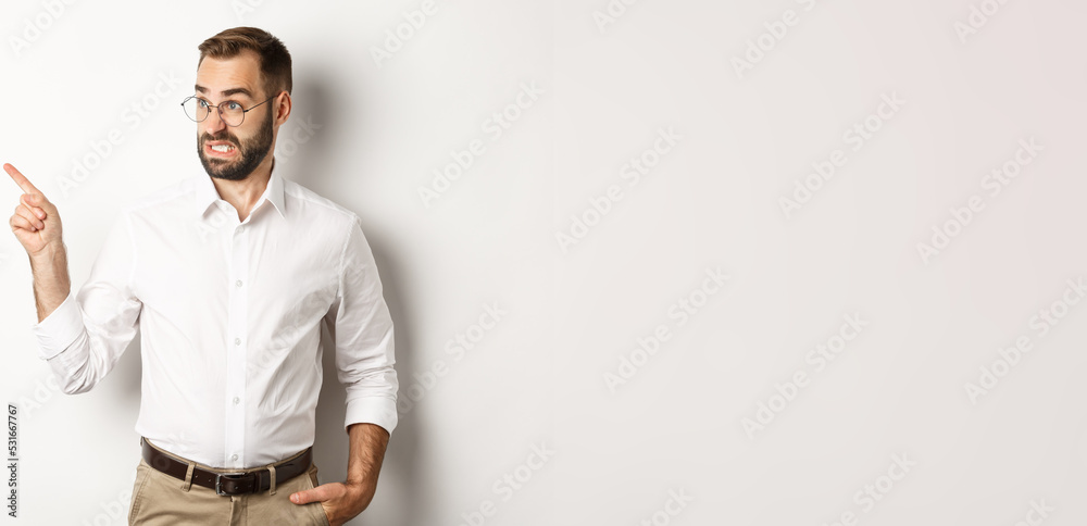 Young bearded guy seeing something disturbing, cringe while pointing ...