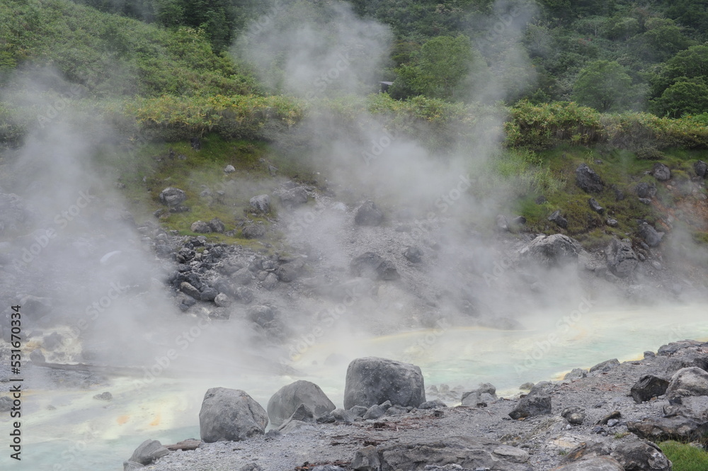 Acidic hot spring stream water with hydrochloric acid emitting steam in ...