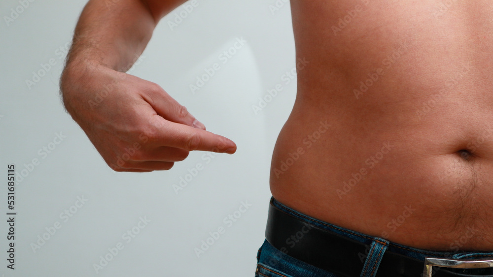 Man holding his excess fat around his waist. Pinch belly side ...