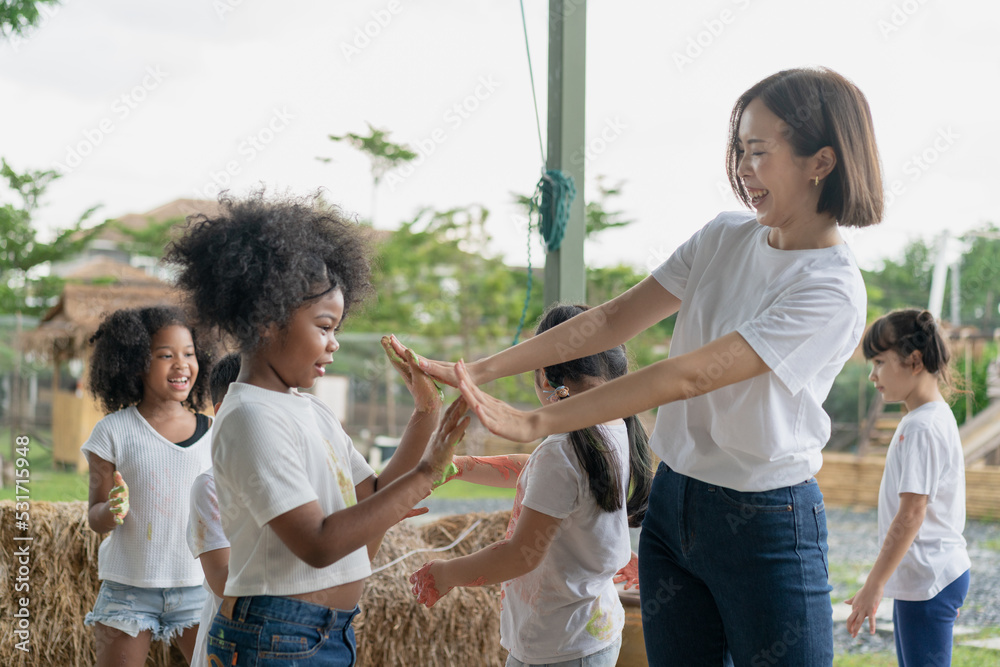 Group of children playing colourful water colours and colour stain on ...