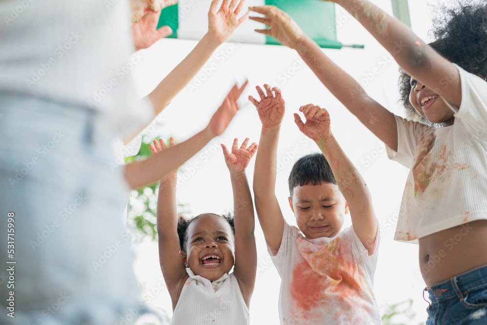 Group of children playing colourful water colours and colour stain on ...