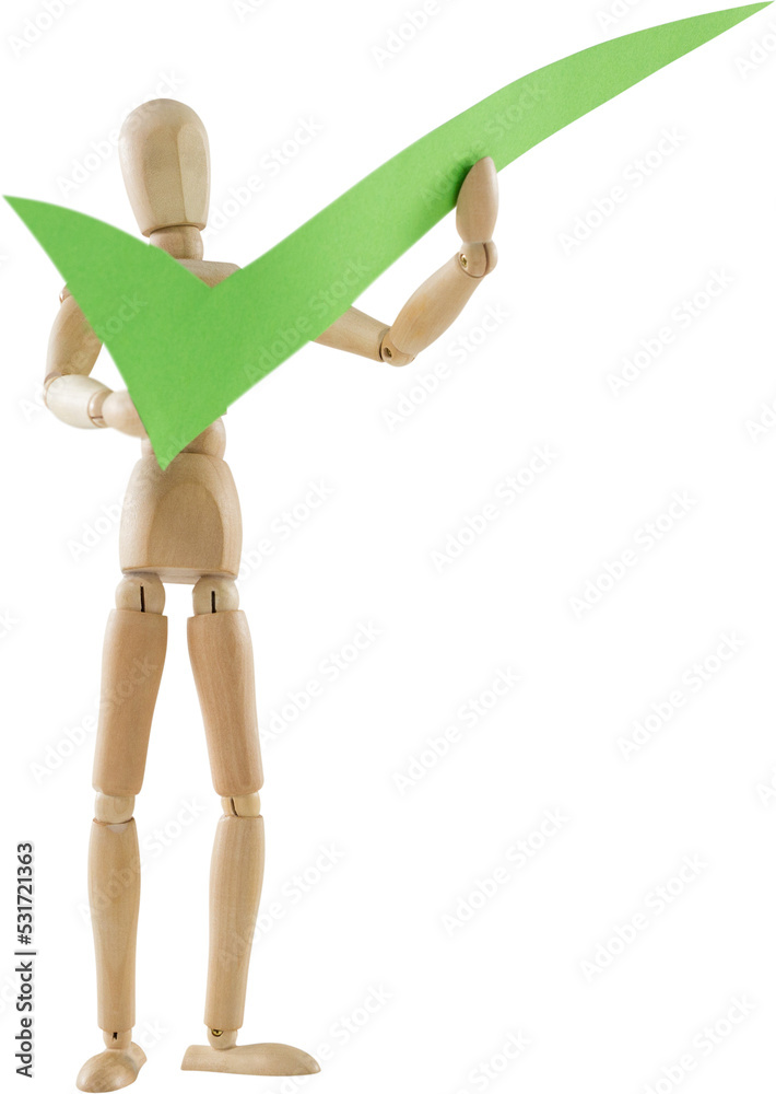 Image of wooden man model holding big green tick sign Stock Photo ...