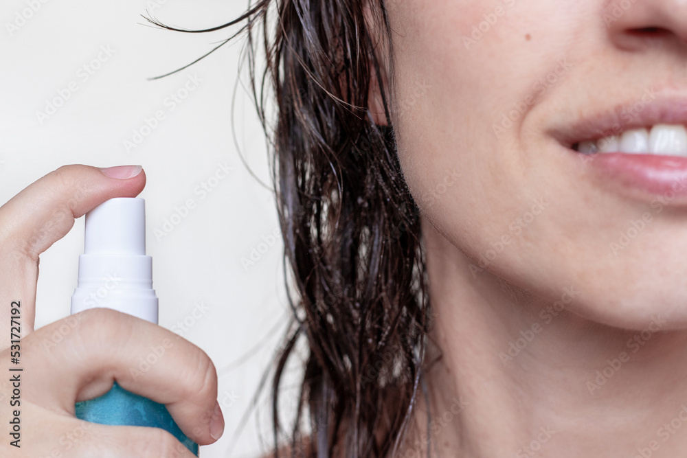 woman using spray on wet hair isolated.smiling girl with wet hair long bangs chaotic on face ...
