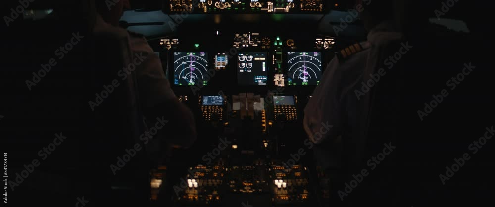 Commercial aircraft pilots performing pre flight check of the jet ...